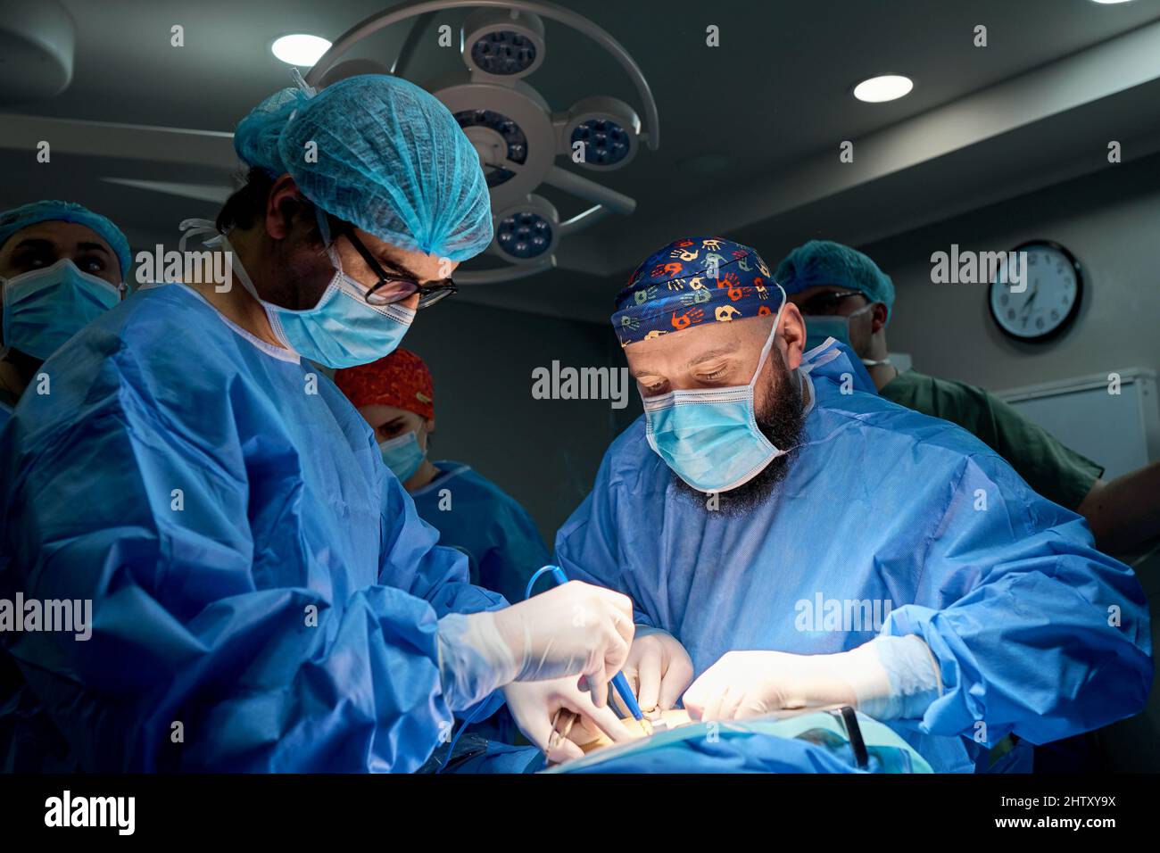 doctors in the operating room perform surgery on a patient Stock Photo ...