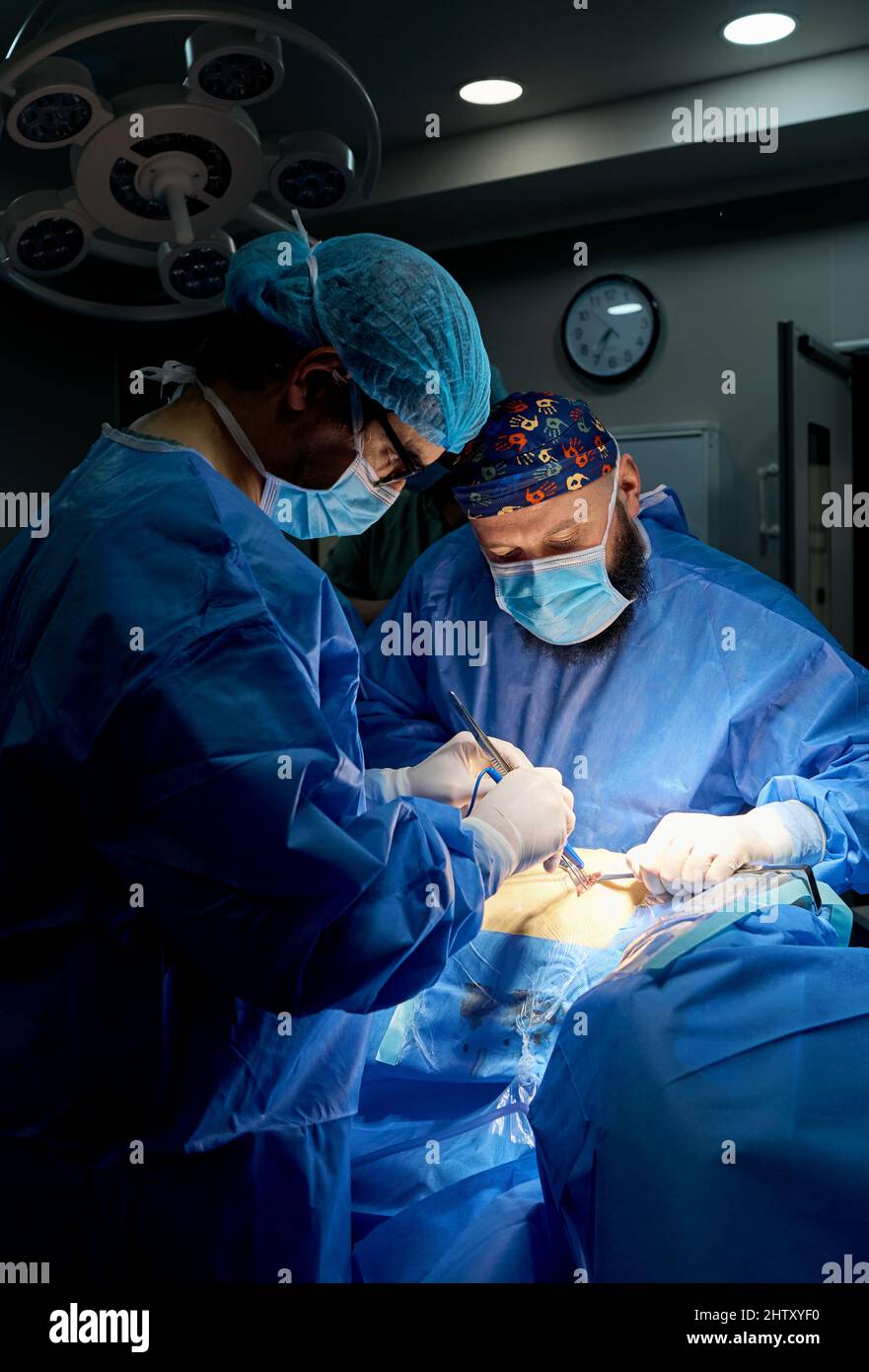 doctors in the operating room perform surgery on a patient Stock Photo ...