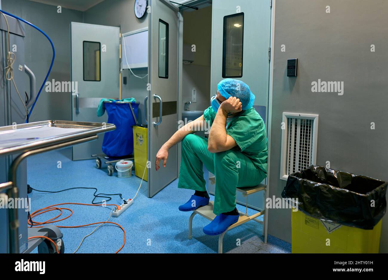 doctor tired after the operation is sitting on the floor Stock Photo ...
