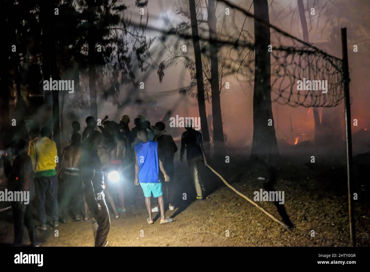 Nairobi, Kenya. 01st Mar, 2022. Residents struggle to put out a night ...