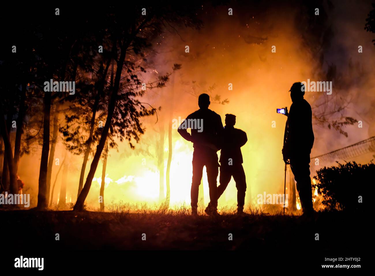 Nairobi, Kenya. 01st Mar, 2022. A man takes pictures during a fire ...