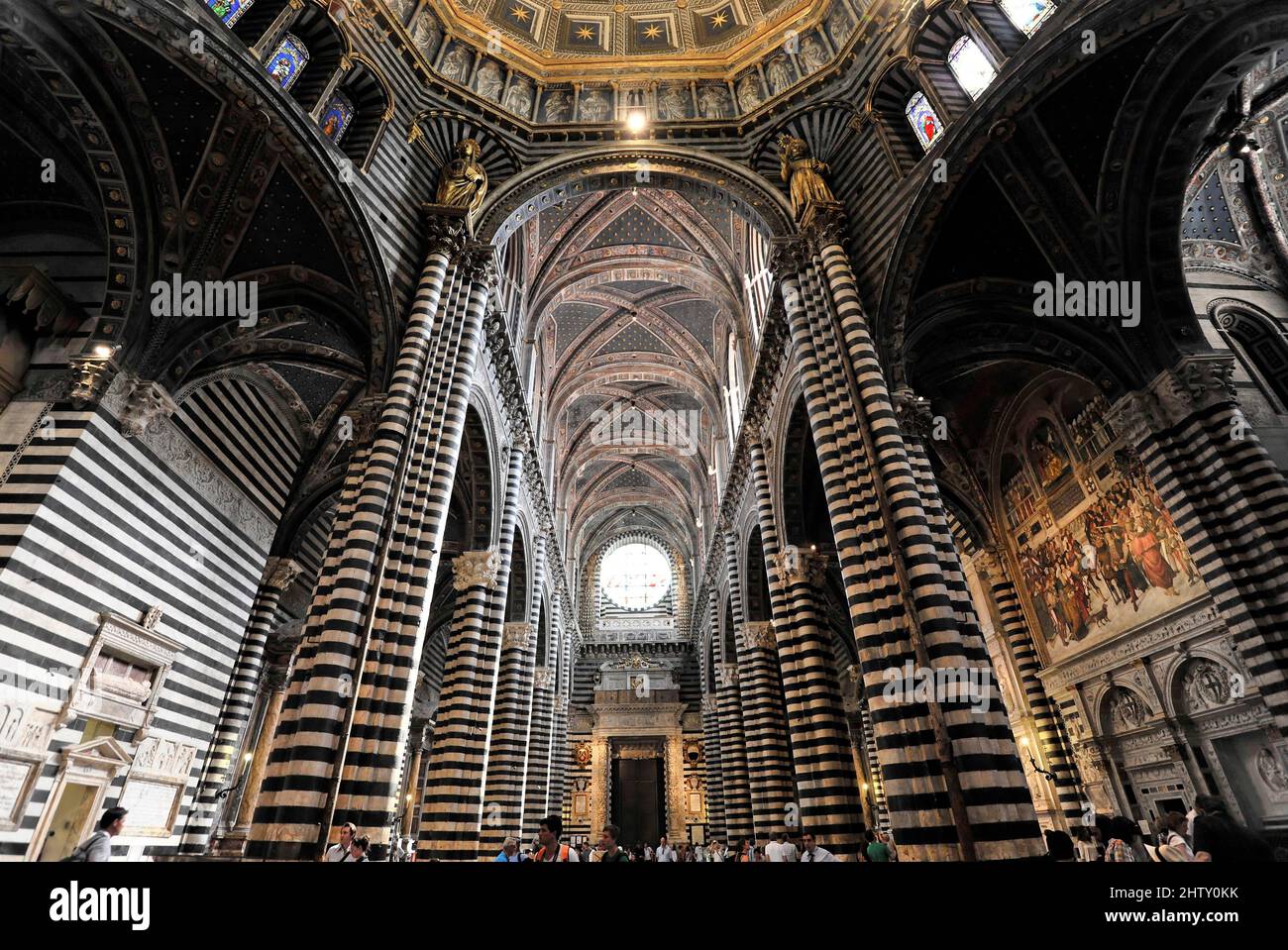Interior with striped columns and decorated ceiling, Siena Cathedral or ...