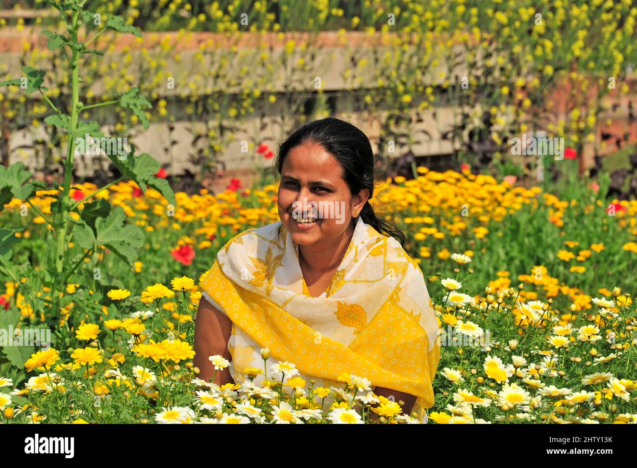 Young Indian woman in flower field, Dhamekh Stupa, Isipatana Wildlife ...