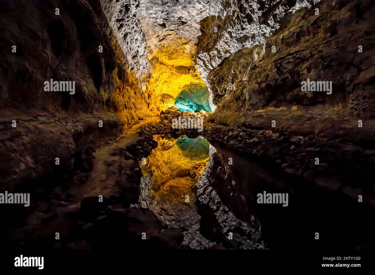 Colourfully illuminated areas of the Cueva de los Verdes, underground ...