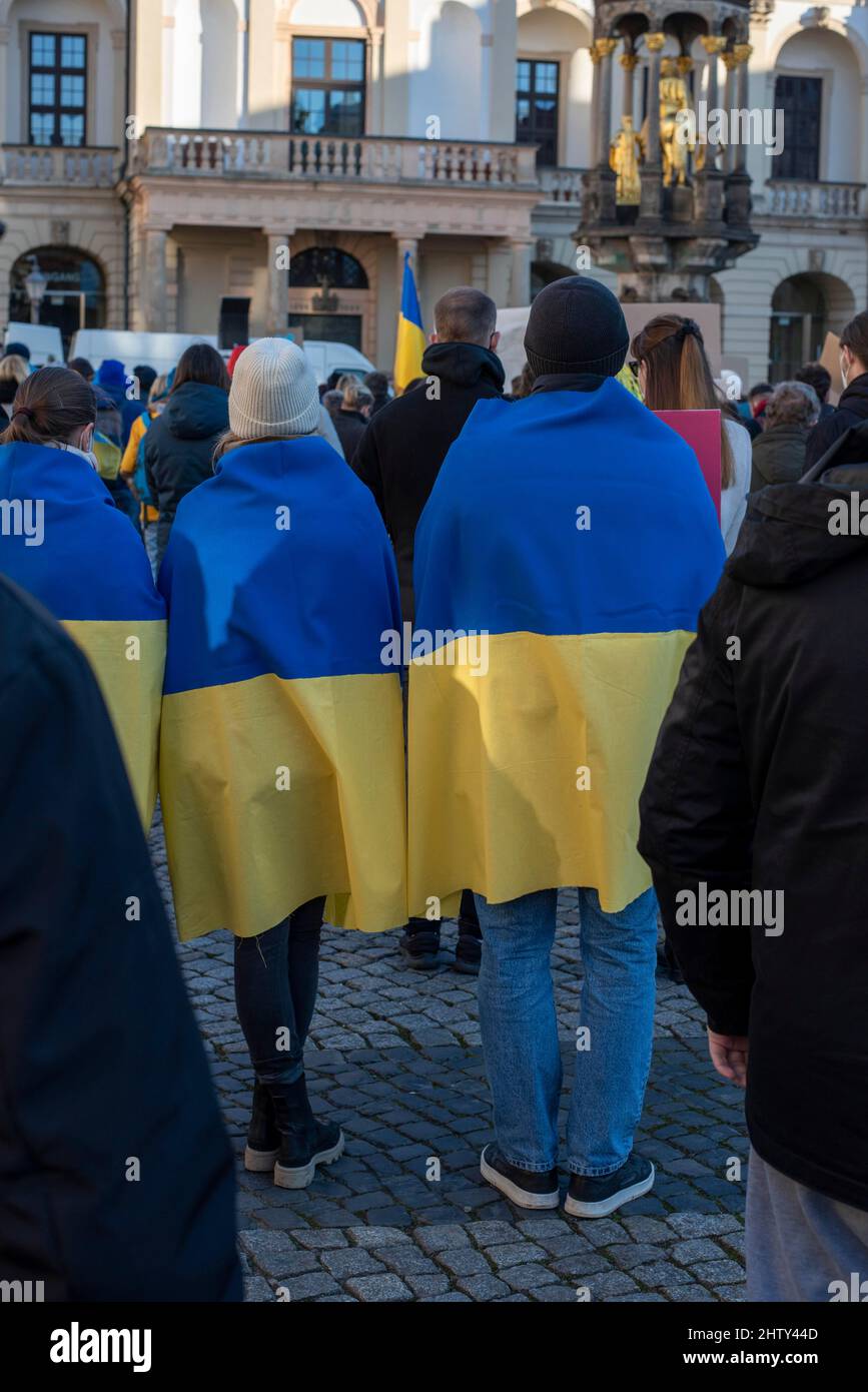 Demonstrators draped in Ukrainian flag, protest rally against Ukraine ...
