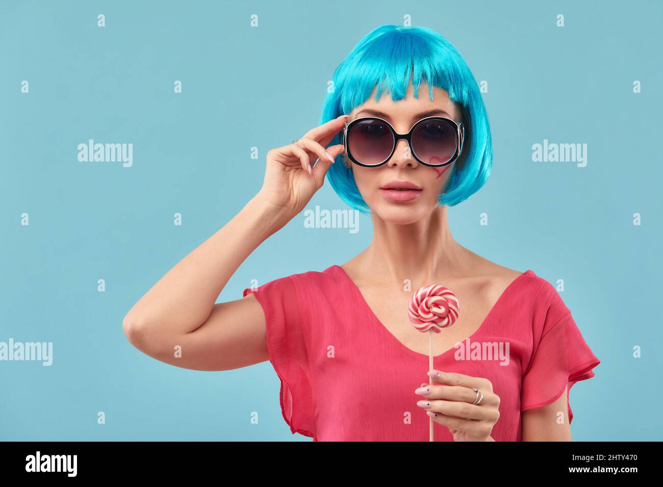 Candy Lolli pop Party Girl posing in white studio. Role-playing games, halloween concept, sweet ...