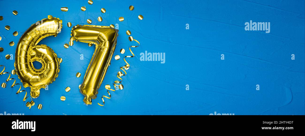 golden yellow foil balloon on blue concrete background number sixty ...