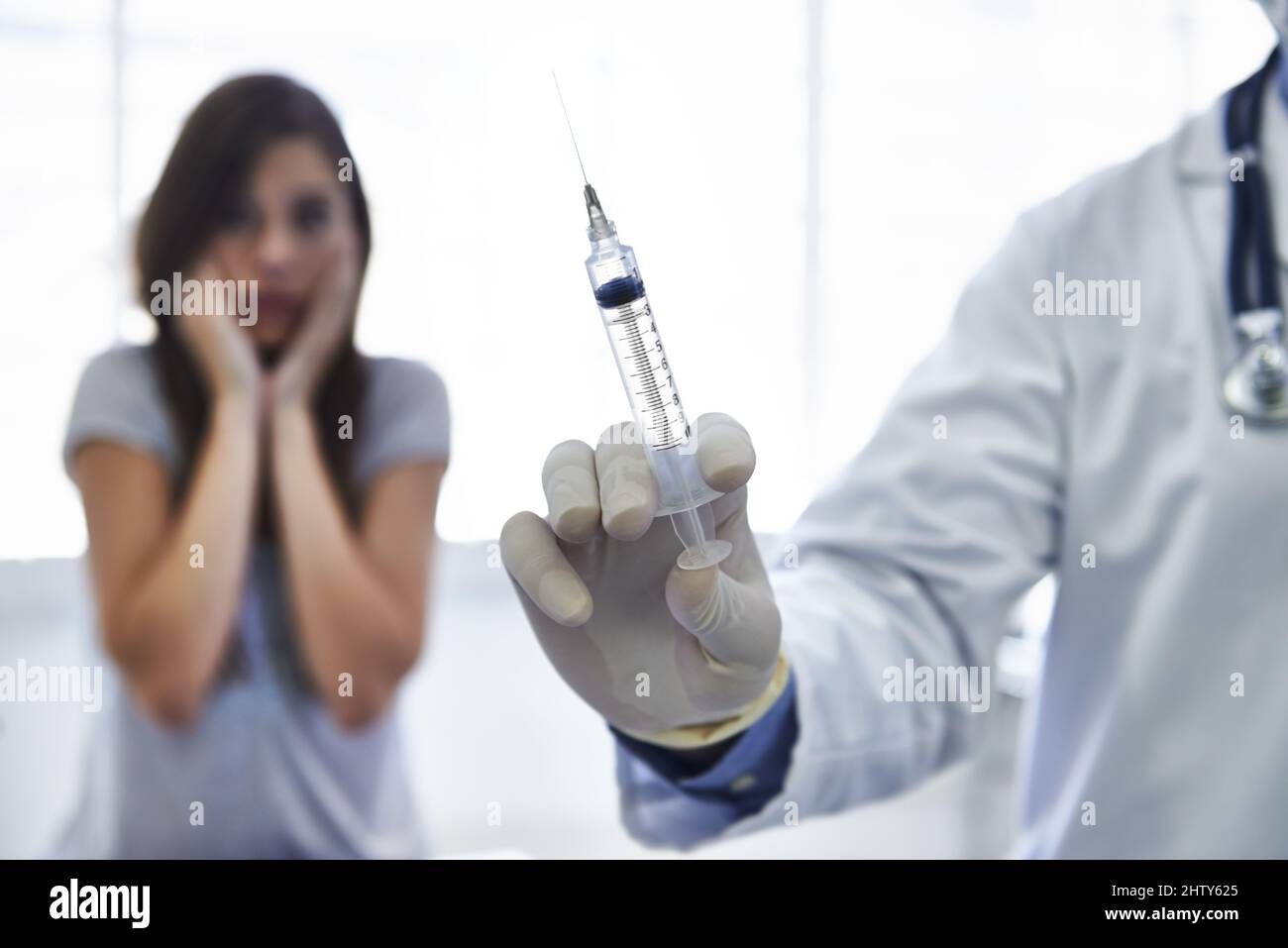 This wont hurt a bit. A doctor giving a woman an injection Stock Photo ...