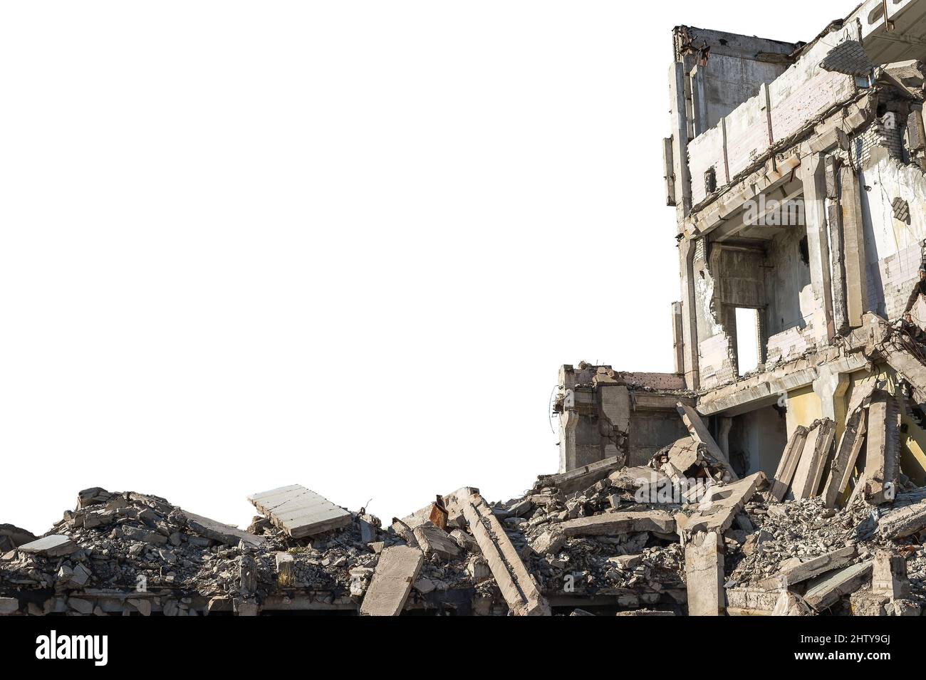 A large ruined building with a pile of construction debris and concrete ...