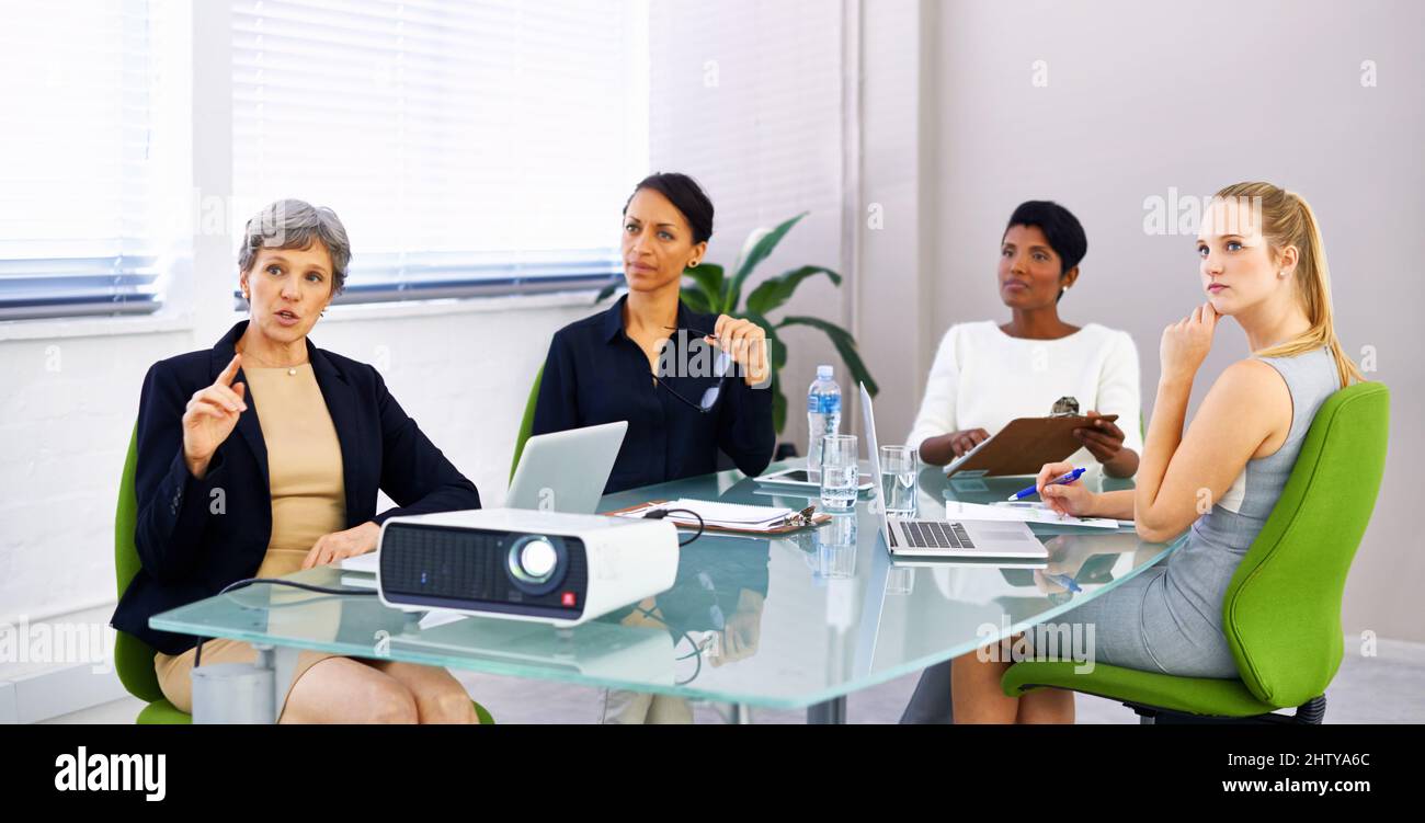 Going over their presentation. Shot of a group of coworkers having a ...