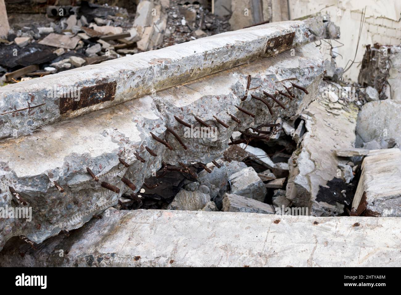 A pile of construction debris in close-up of concrete beams with ...