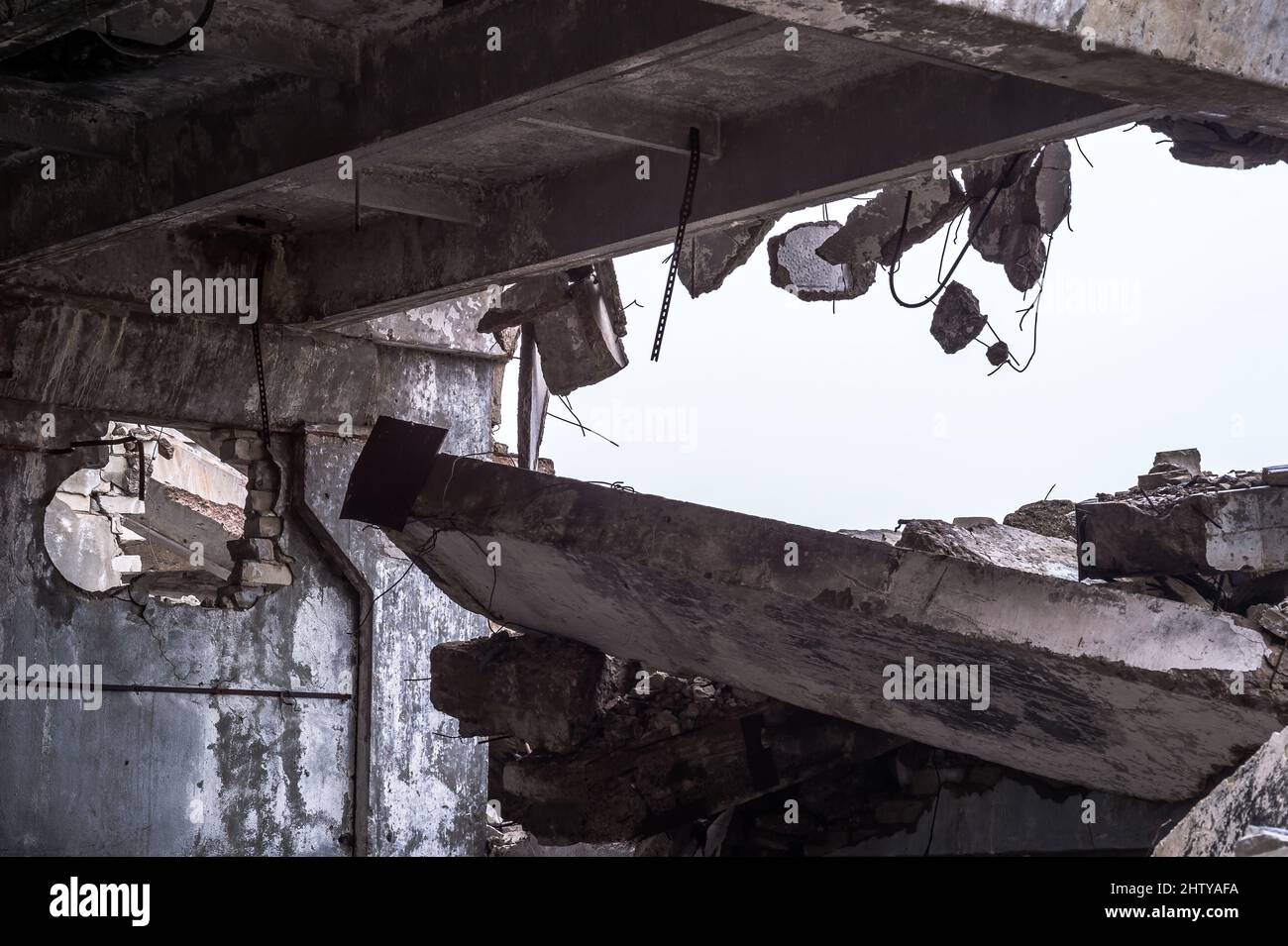 The destroyed wall of the building is a close-up with large concrete ...
