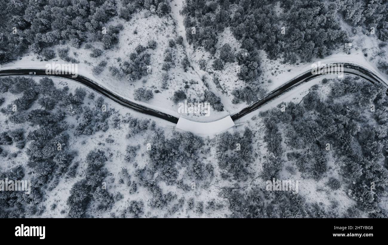Aerial view of a long driving trail through snowy mountains Stock Photo ...