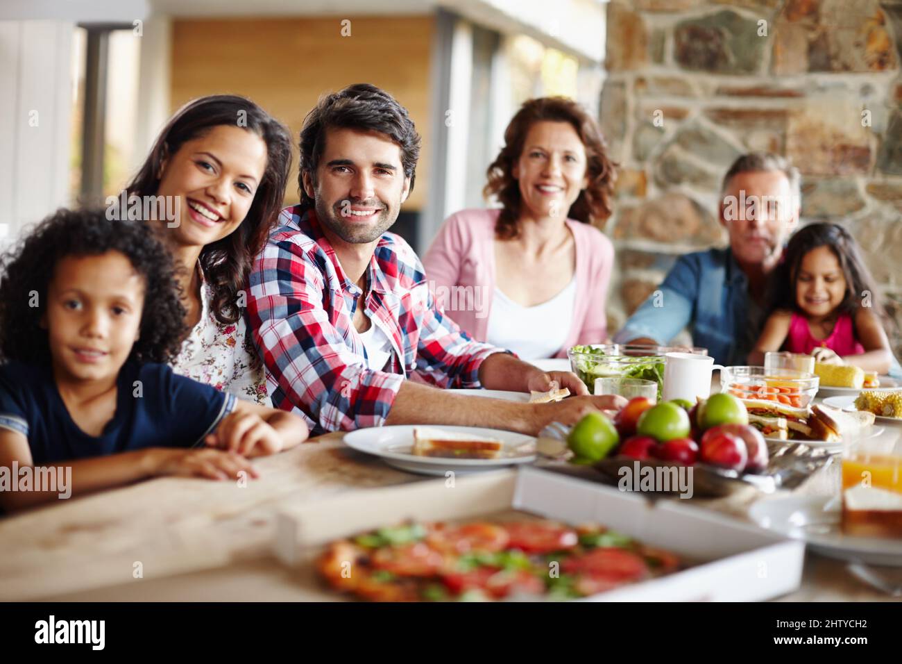 They enjoy bonding over meals. A happy family enjoying a meal time ...