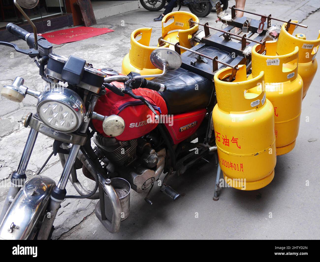 Chinese people worker riding motorcycle stop beside street for use ...