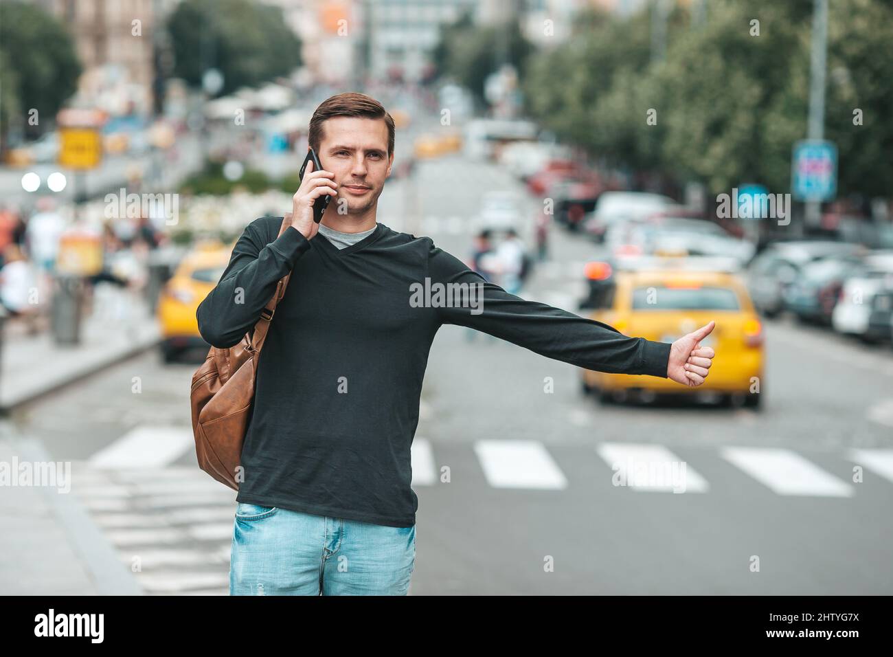 Young man holding mobile phone, using smartphone, making a call and ...