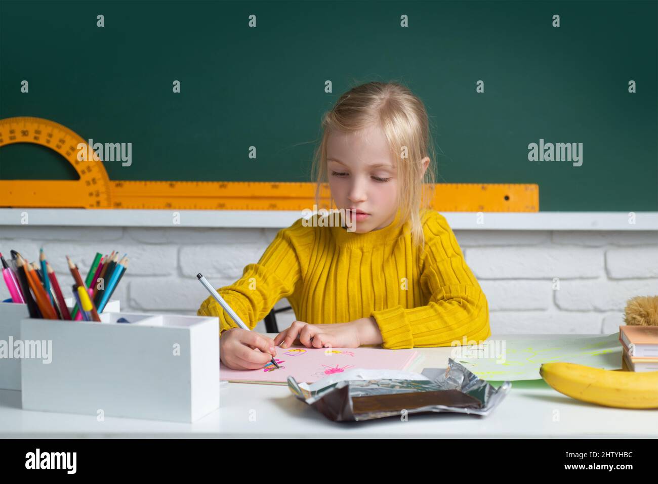 Kid girl learning lesson at school. Elementary school child in class ...