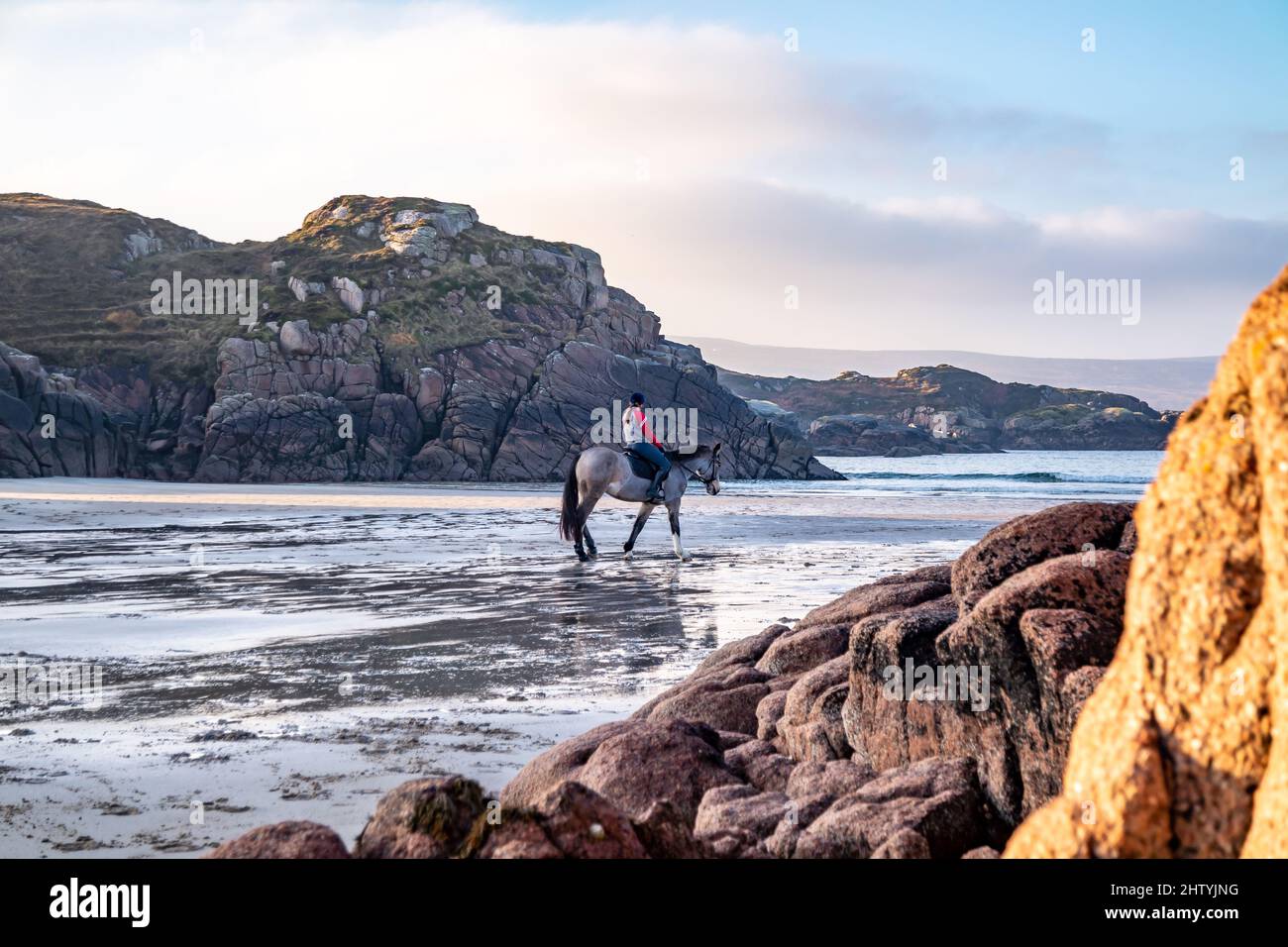 Horse riding at Cloughglass bay and beach by Burtonport in County ...