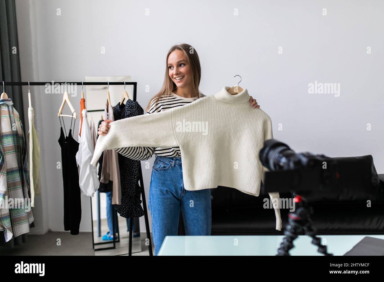 Fashion blogger woman in jeans and turtleneck showing casual colorful ...