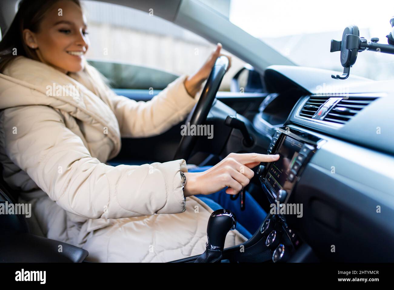 woman changing radio station while driving car Stock Photo - Alamy