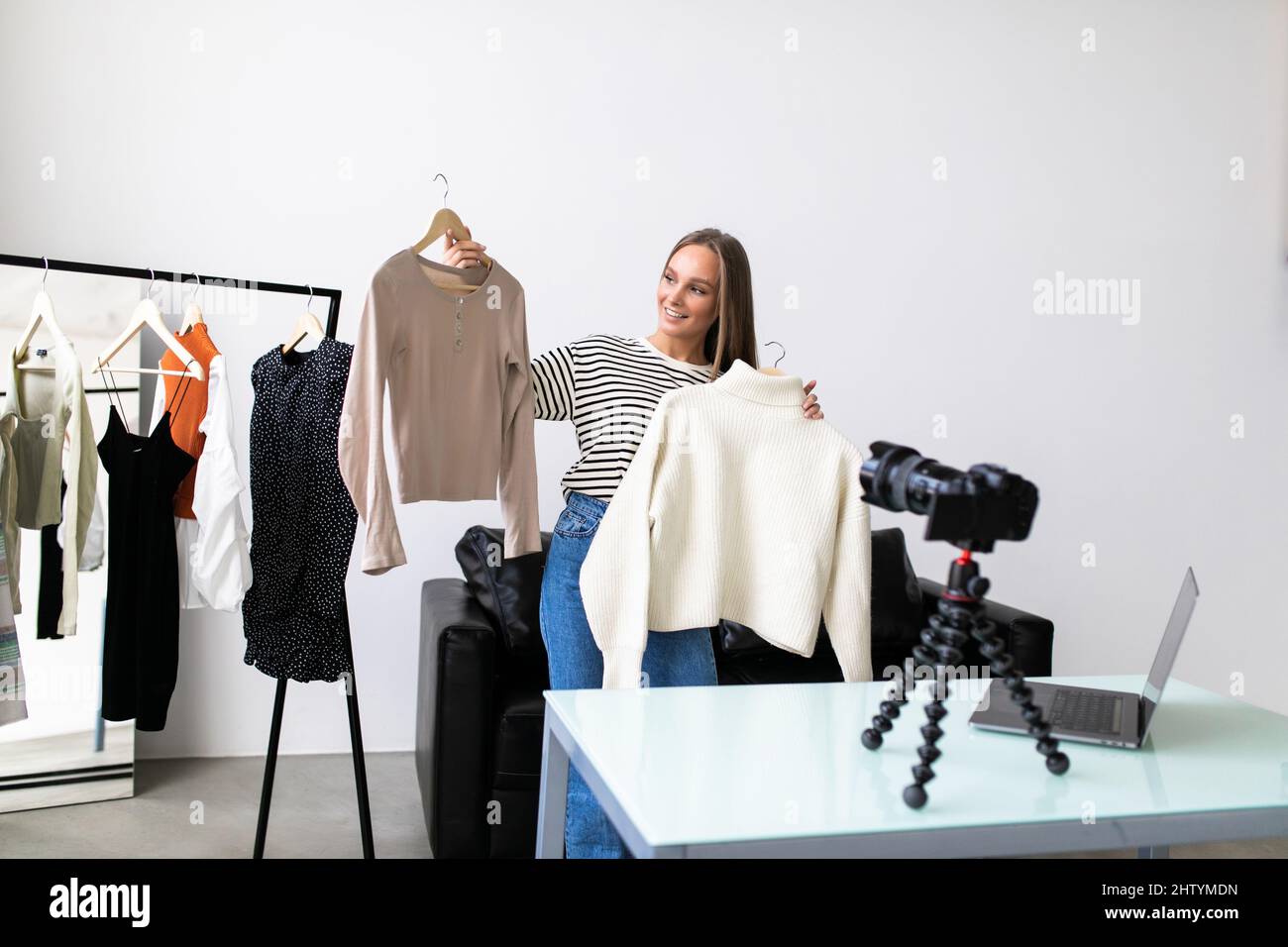 Fashion blogger woman in jeans and turtleneck showing casual colorful ...