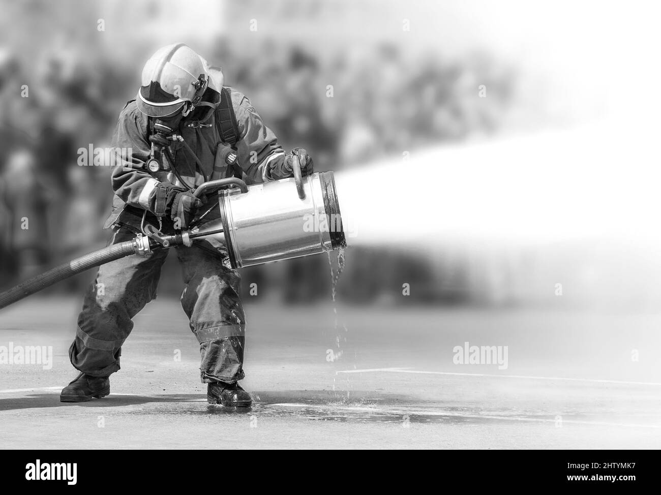 Firefighters extinguishing foam Black and White Stock Photos & Images ...