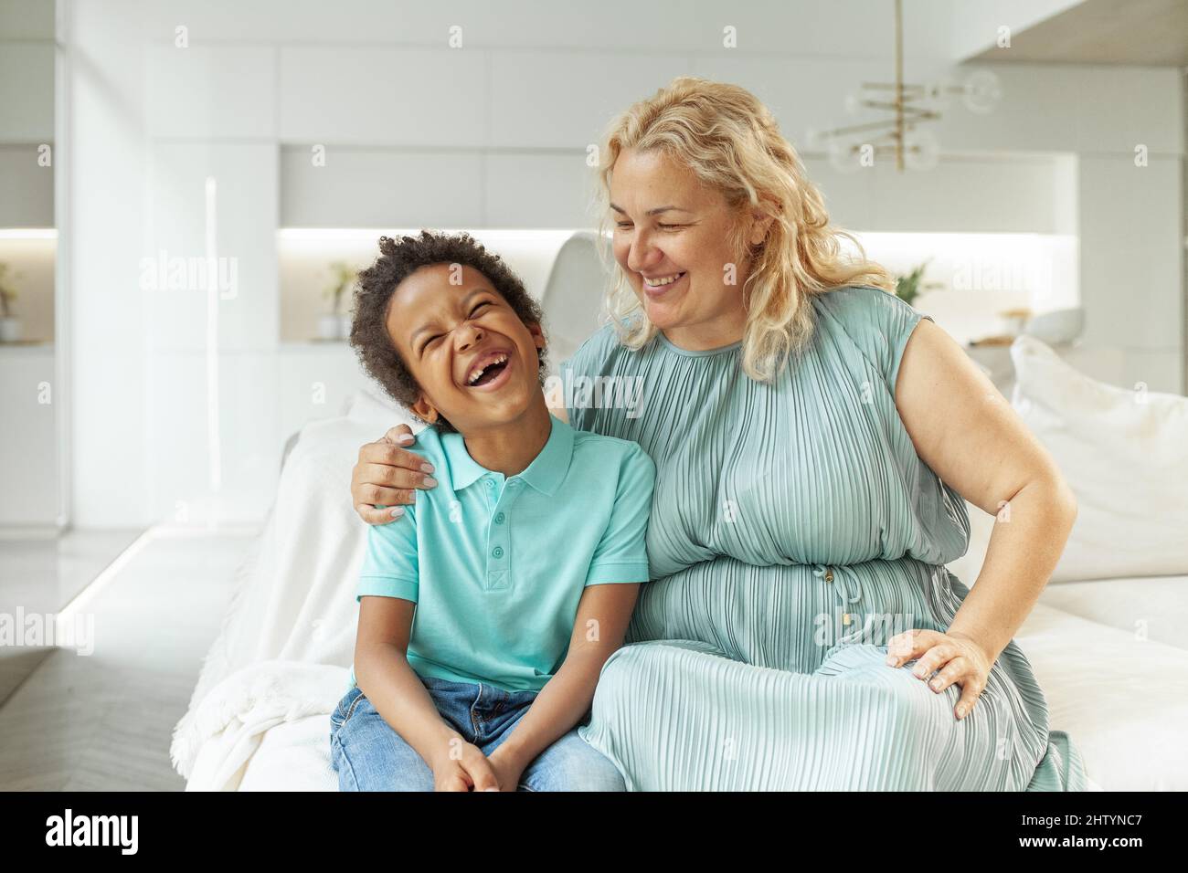 Happy mom and son laughing at home Stock Photo - Alamy
