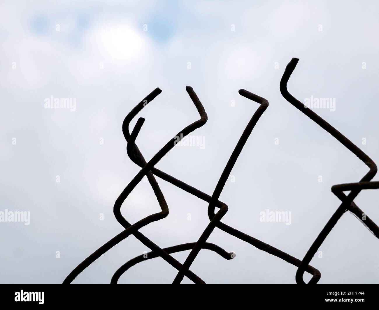 Abstract bent damaged destroyed grate fence coming undone detail, scary ...