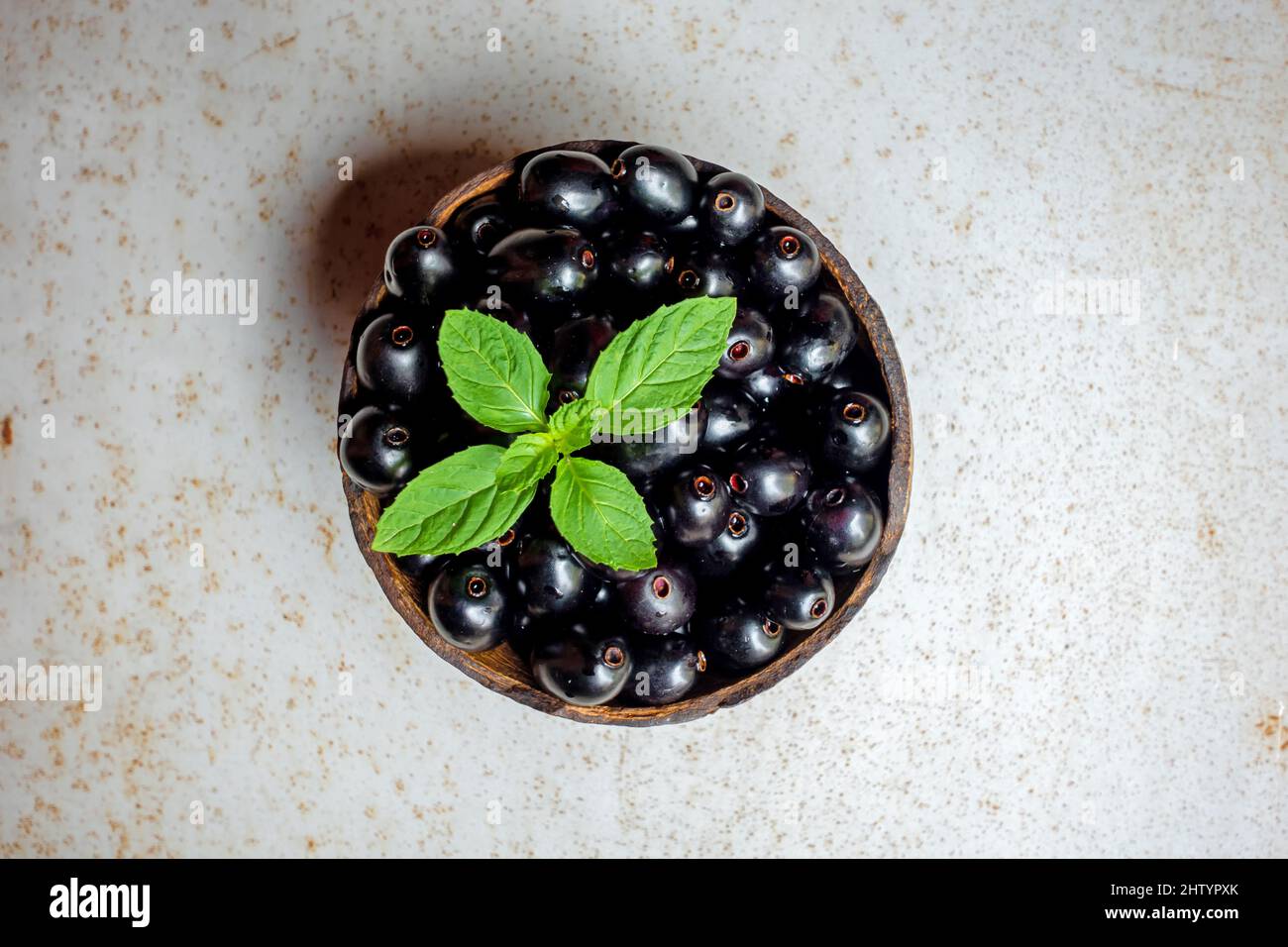 Black ripe Syzygium cumini fruits. Dark black java plum in a wood bowl ...