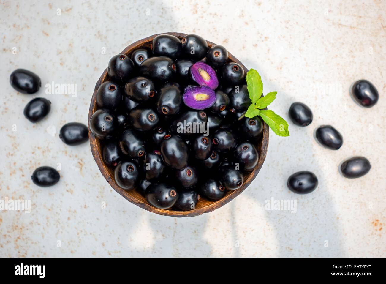 Black ripe Syzygium cumini fruits. Dark black java plum in a wood bowl ...
