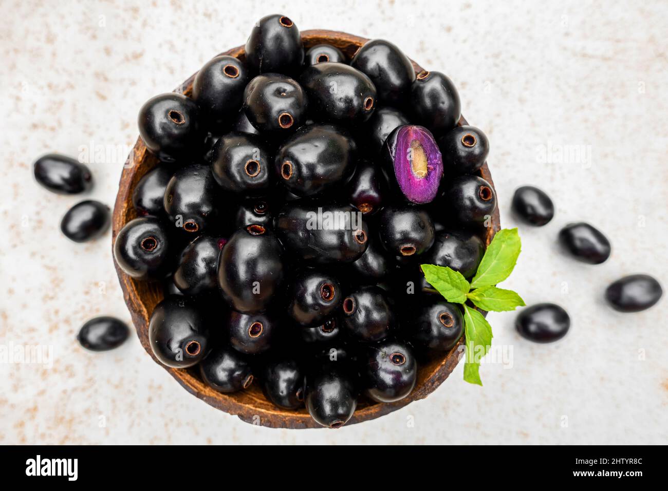 Black ripe Syzygium cumini fruits. Dark black java plum in a wood bowl ...