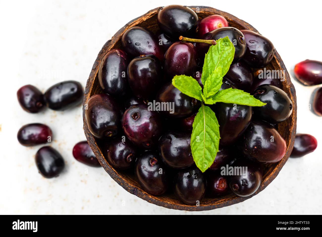 Dark pink-red ripe Syzygium cumini fruits. Dark black java plum in a ...