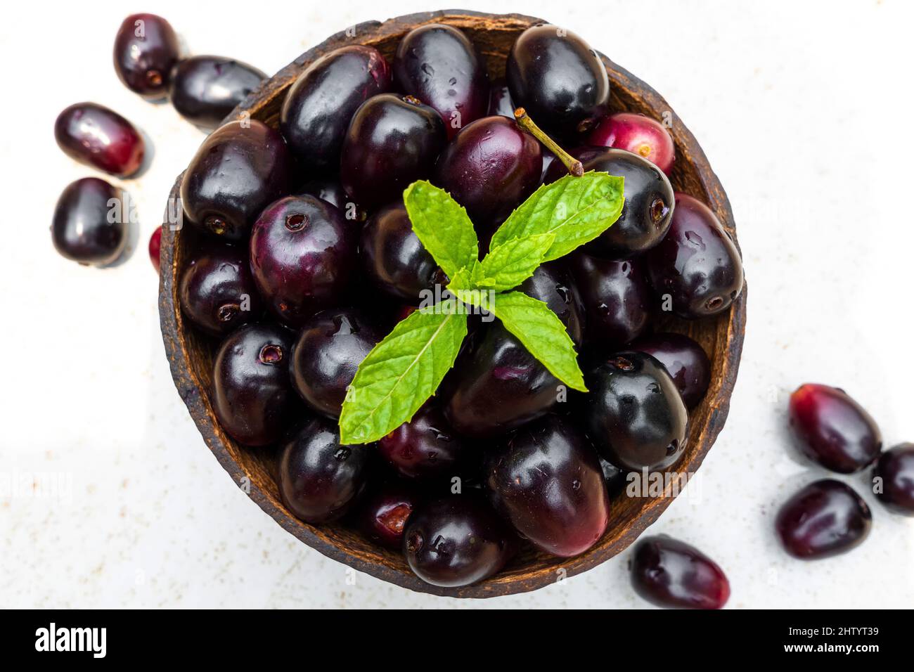 Dark pink-red ripe Syzygium cumini fruits. Dark black java plum in a ...