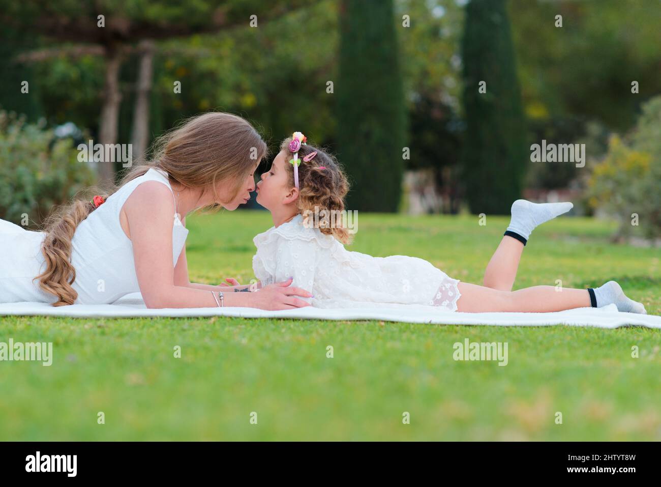 Daughter kisses her mother's nose with feeling and affection in the ...