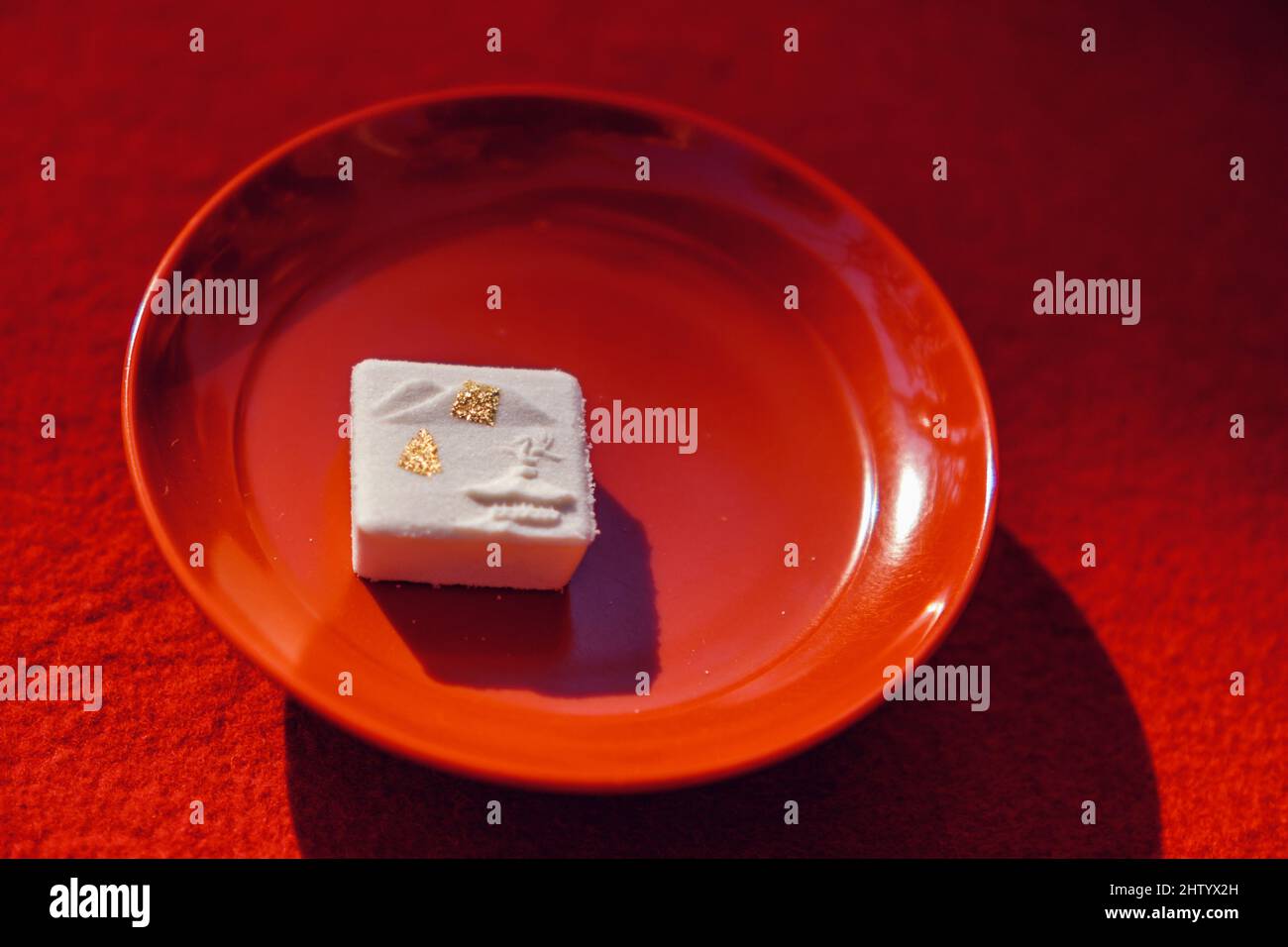 Traditional Japanese sweet on a red plate at the Golden Pavillion in ...