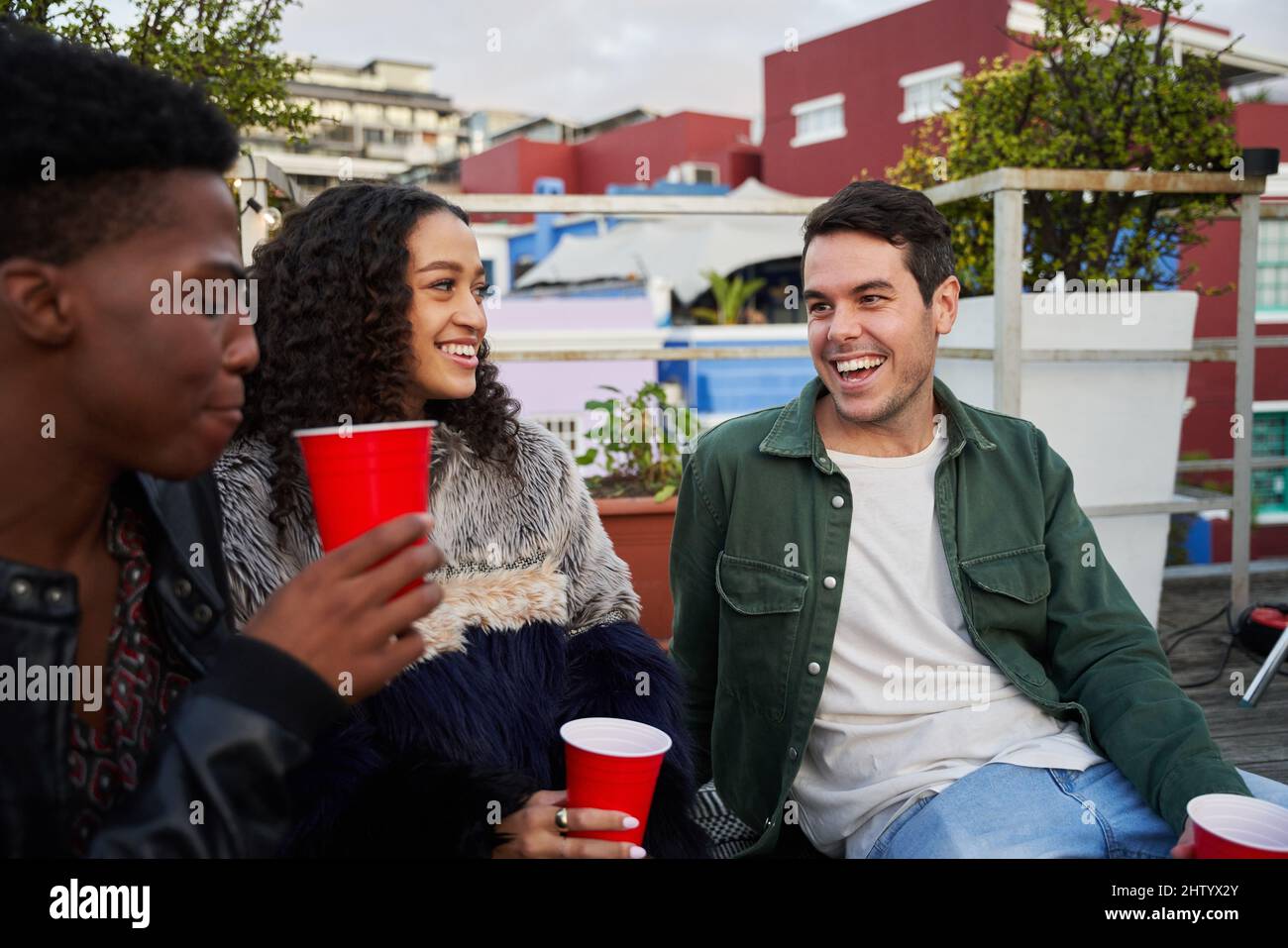 Group of multi-cultural young adult friends laughing at joke together ...