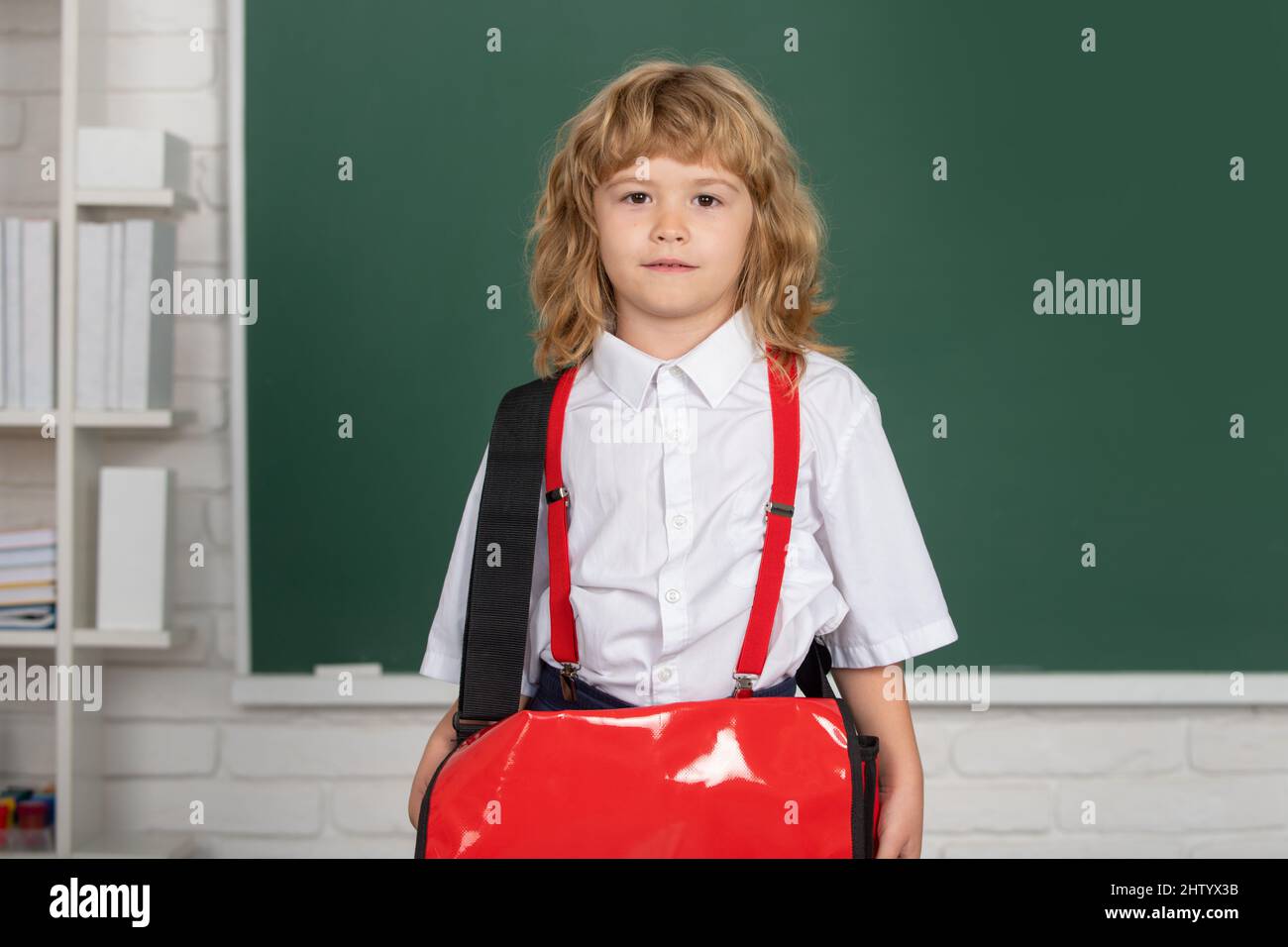Portrait of cute, lovely, boy with backpack in school uniform in ...