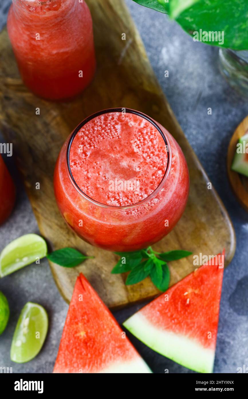 Jus Semangka or watermelon juice, cut on wooden chopping board with ...