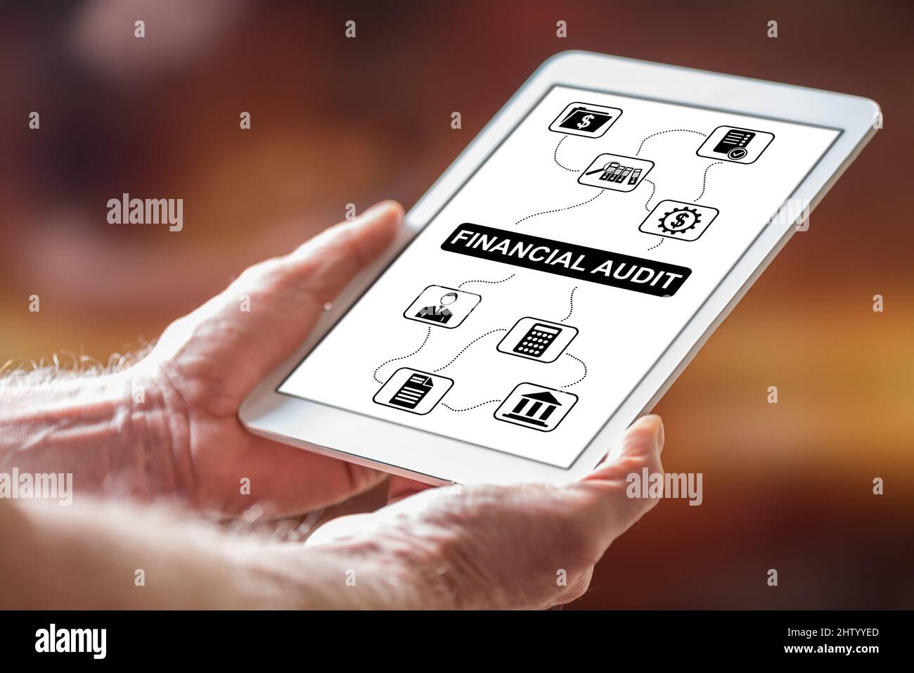 Man holding a tablet showing financial audit concept Stock Photo - Alamy