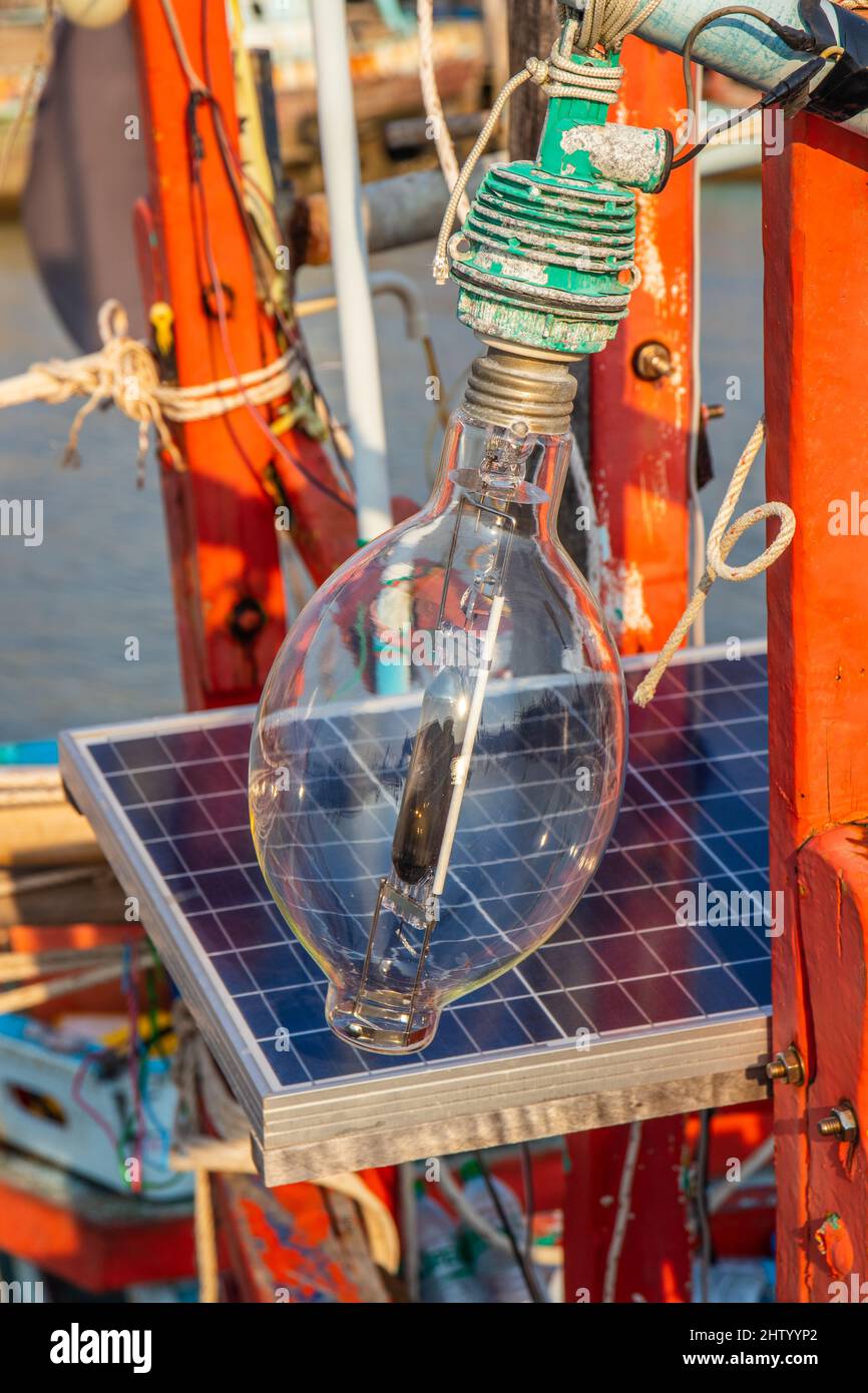 A halogen lamp with a solar battery charging station on the deck of a ...