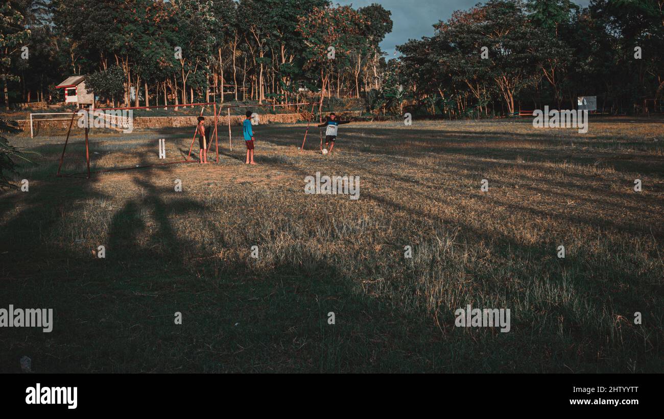 playing football in the field in the afternoon in Wonogiri Stock Photo ...