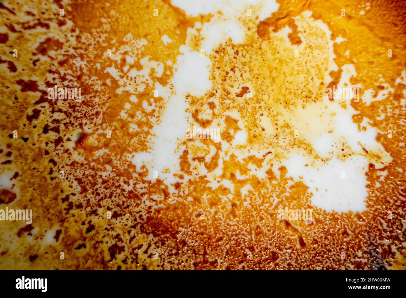 Abstract yellow-orange burning cream texture in white background. Milk ...