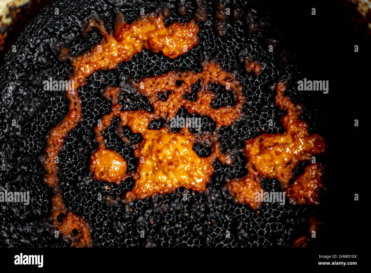 Deep dark abstract yellow-orange burning cream texture. Milk burning ...