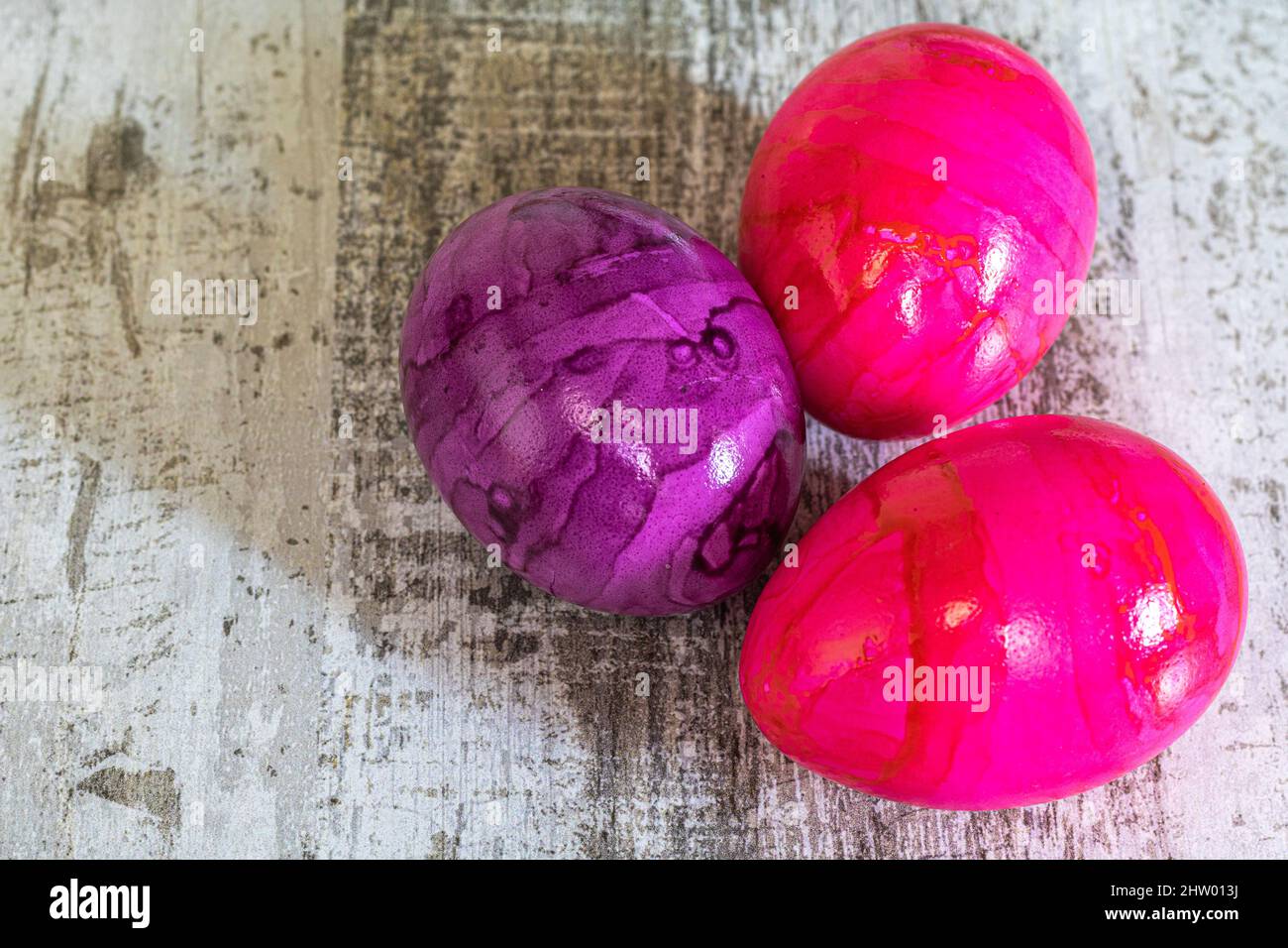 three colored eggs on a kitchen countertop. Pre-cooked eggs sold not ...