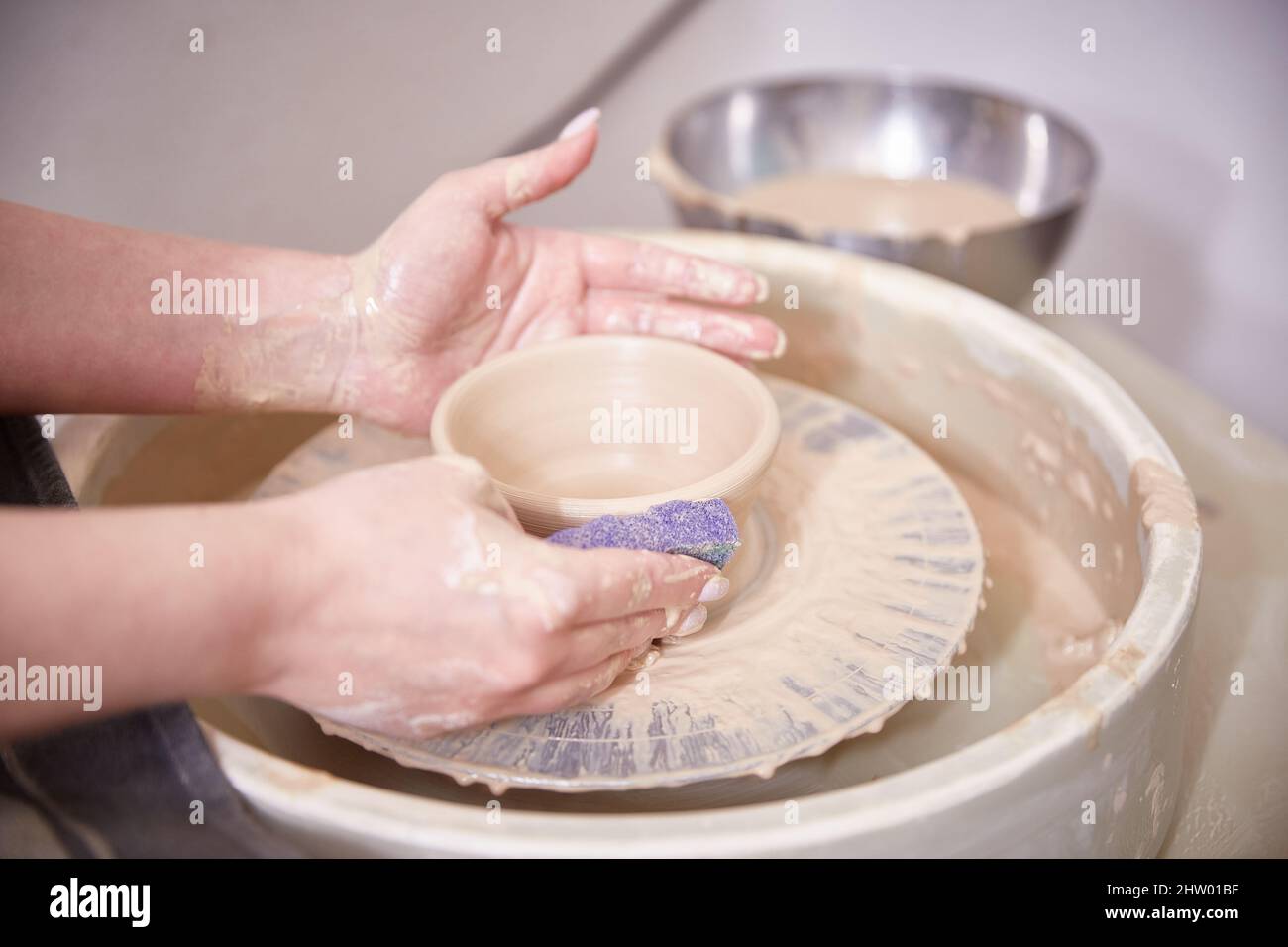 Beautiful women's hands make ceramic dishes on a spinning potter's ...