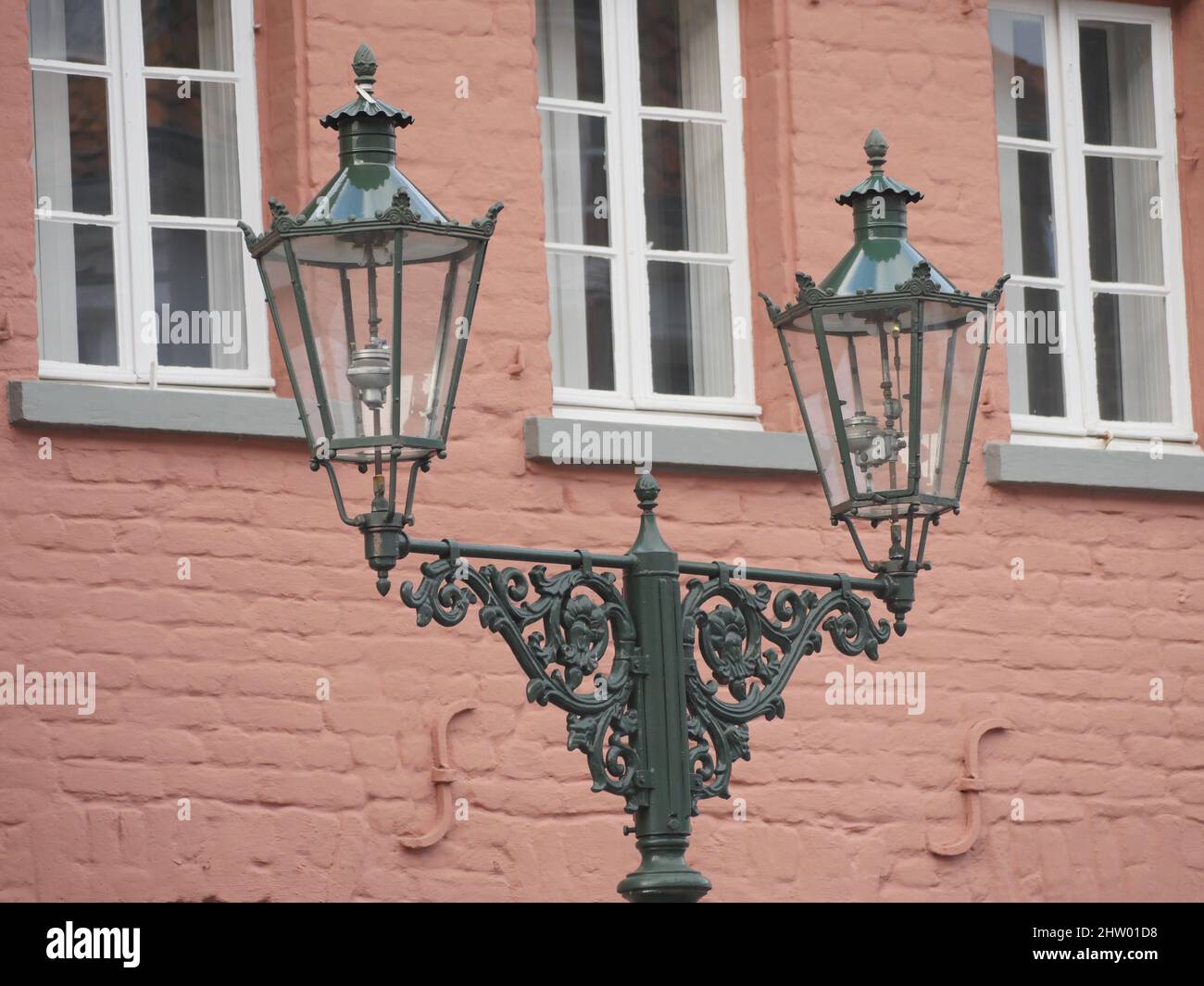 Old gas lanterns in Kaiserswerth Germany in front of a red house Stock ...