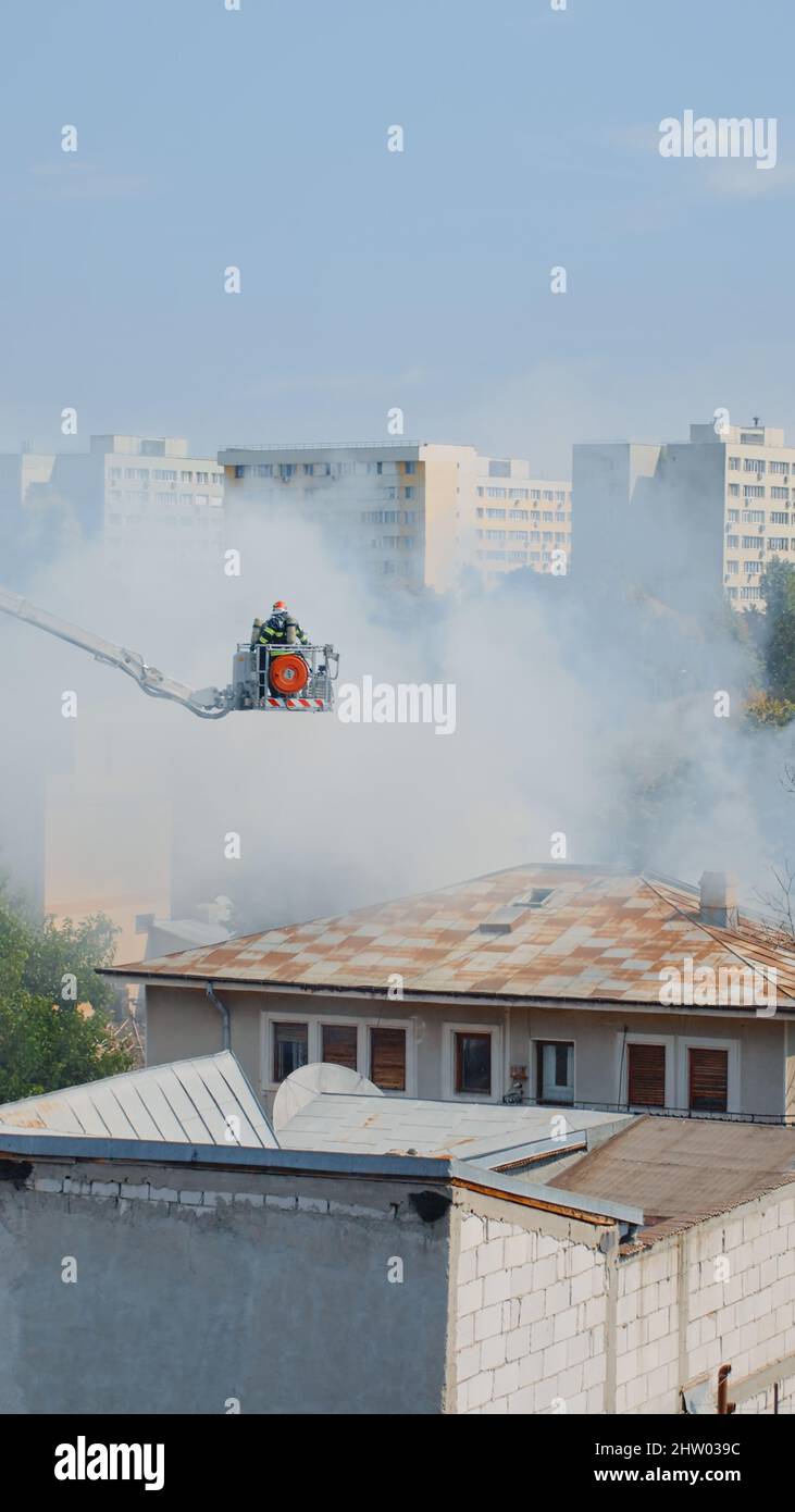 Team of firefighters on service to put out fire from burning house in ...