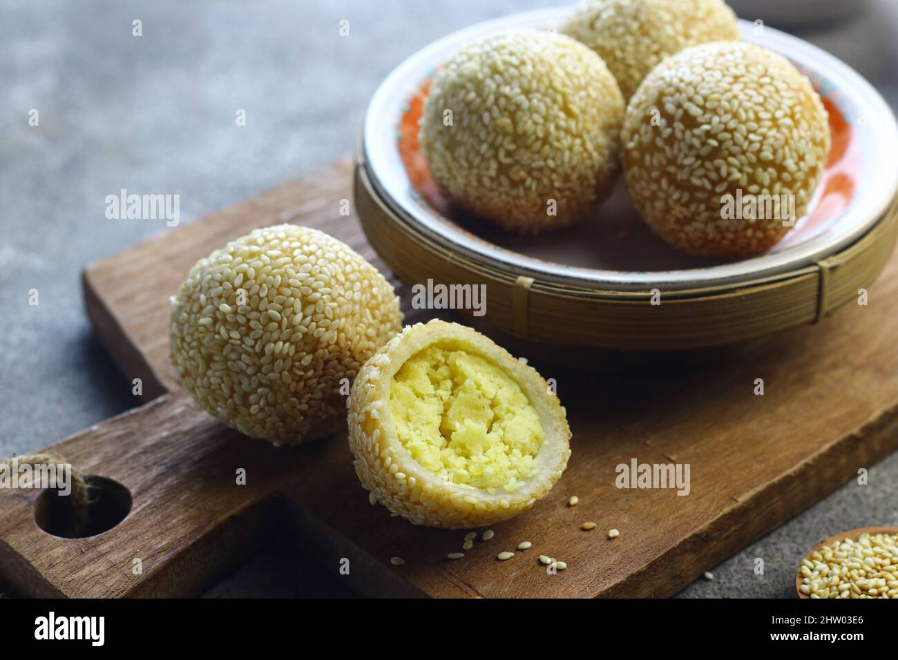 Onde Onde or glutinous rice cake sesame ball on ceramic plate with cups ...