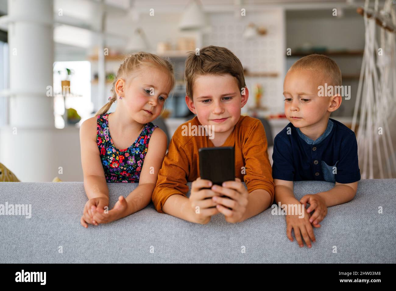 Portrait of happy children using digital devices and having fun ...