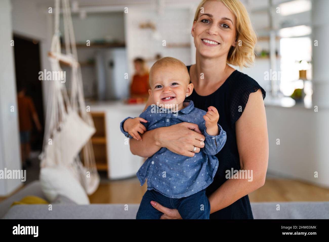 Happy family indoors. Portrait of beautiful mother with cute baby playing smiling together Stock ...